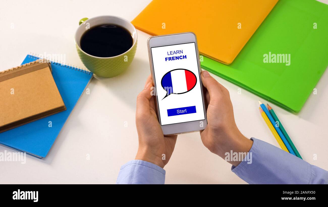 Person showing smartphone with learn French app, foreign language ...
