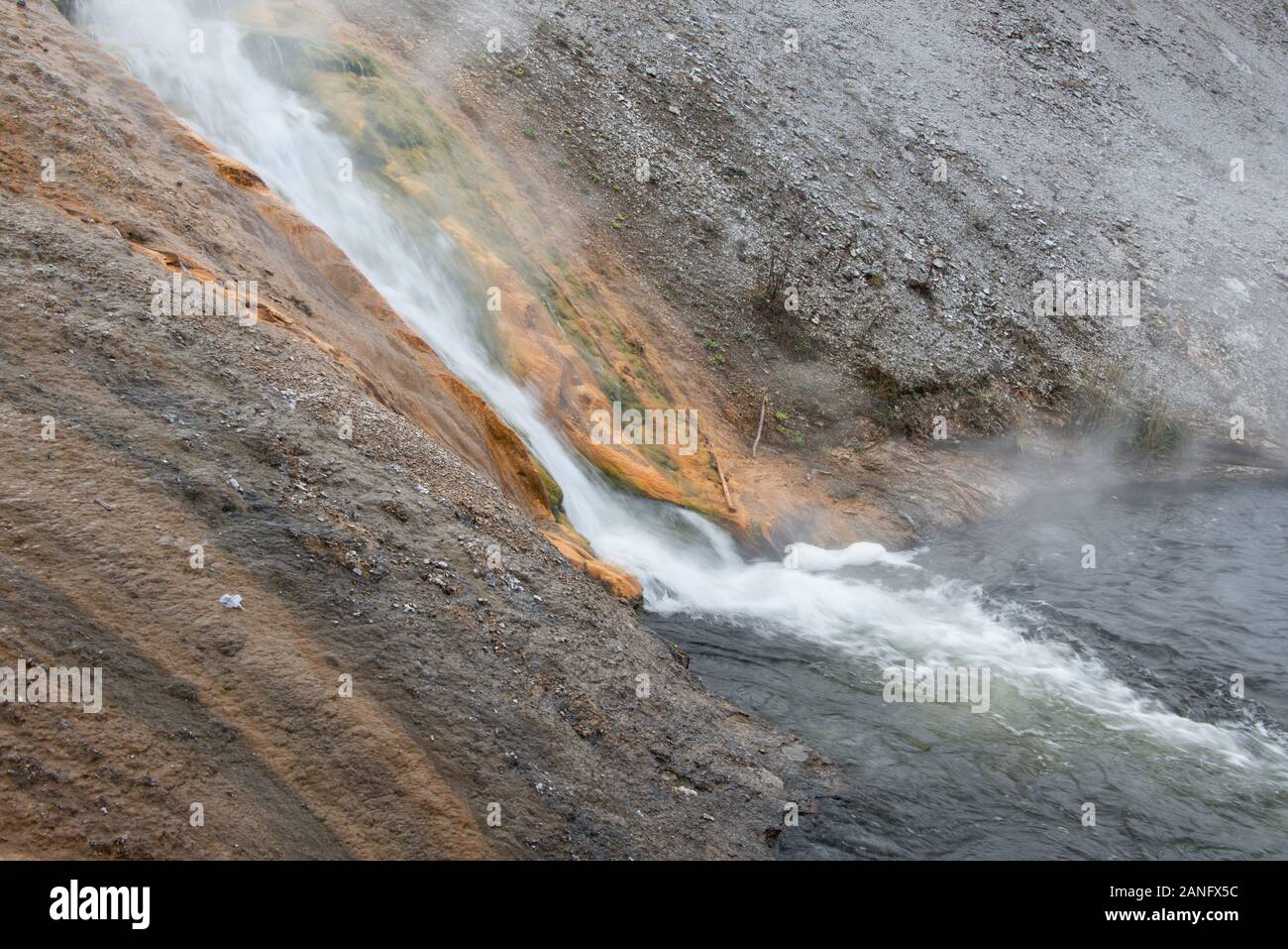 Hot water falls running down the colorful rocks in Yellowstone National ...