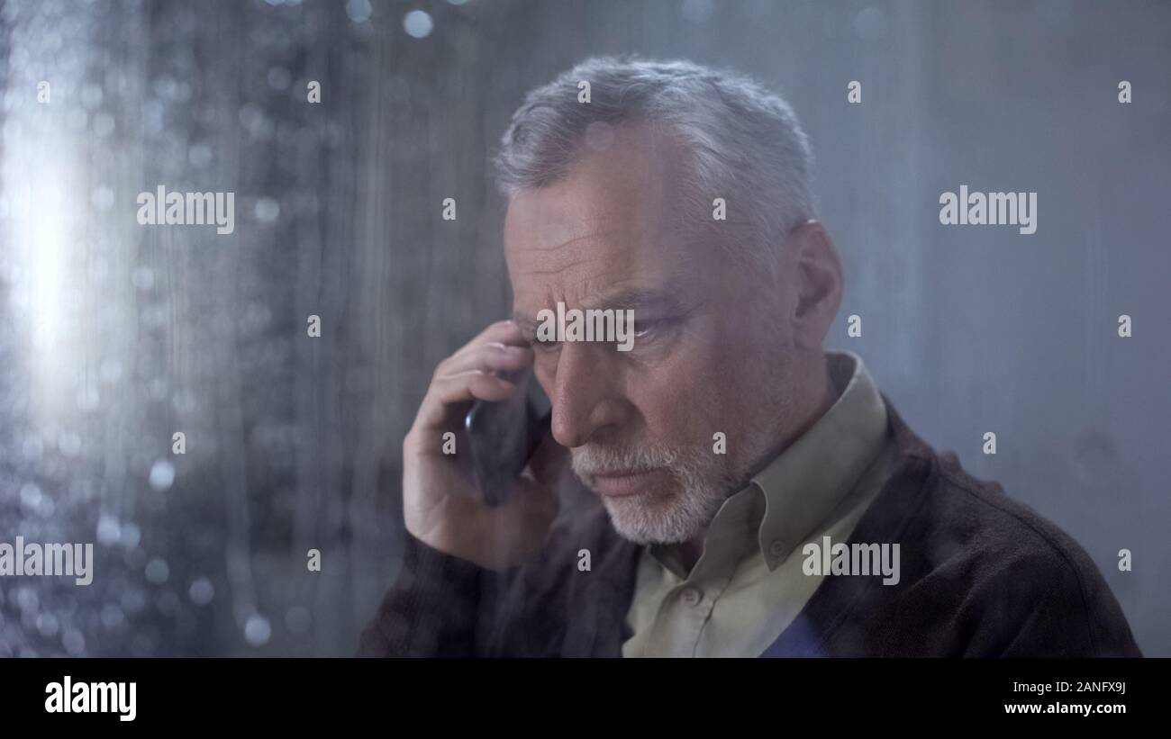 Depressed senior man talking on phone, family communication, old age ...