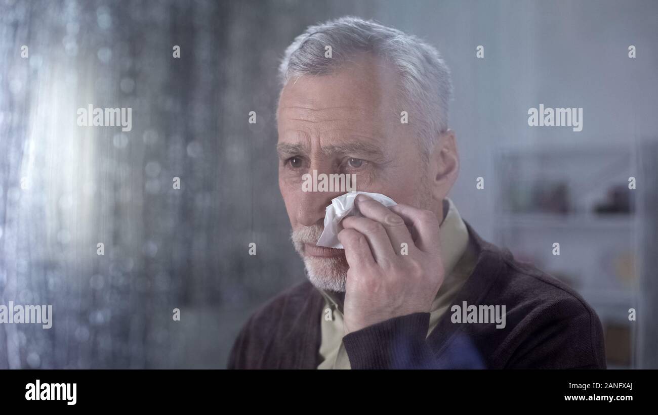 Upset retired man crying at home, thinking of problem, sad memories ...