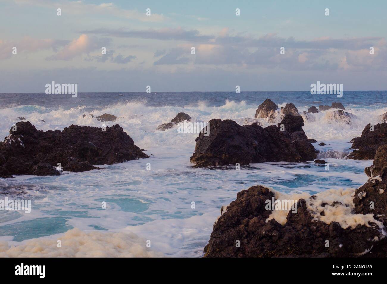 Lava stones on the beach of Piscinas Naturais Biscoitos. Atlantic Ocean ...
