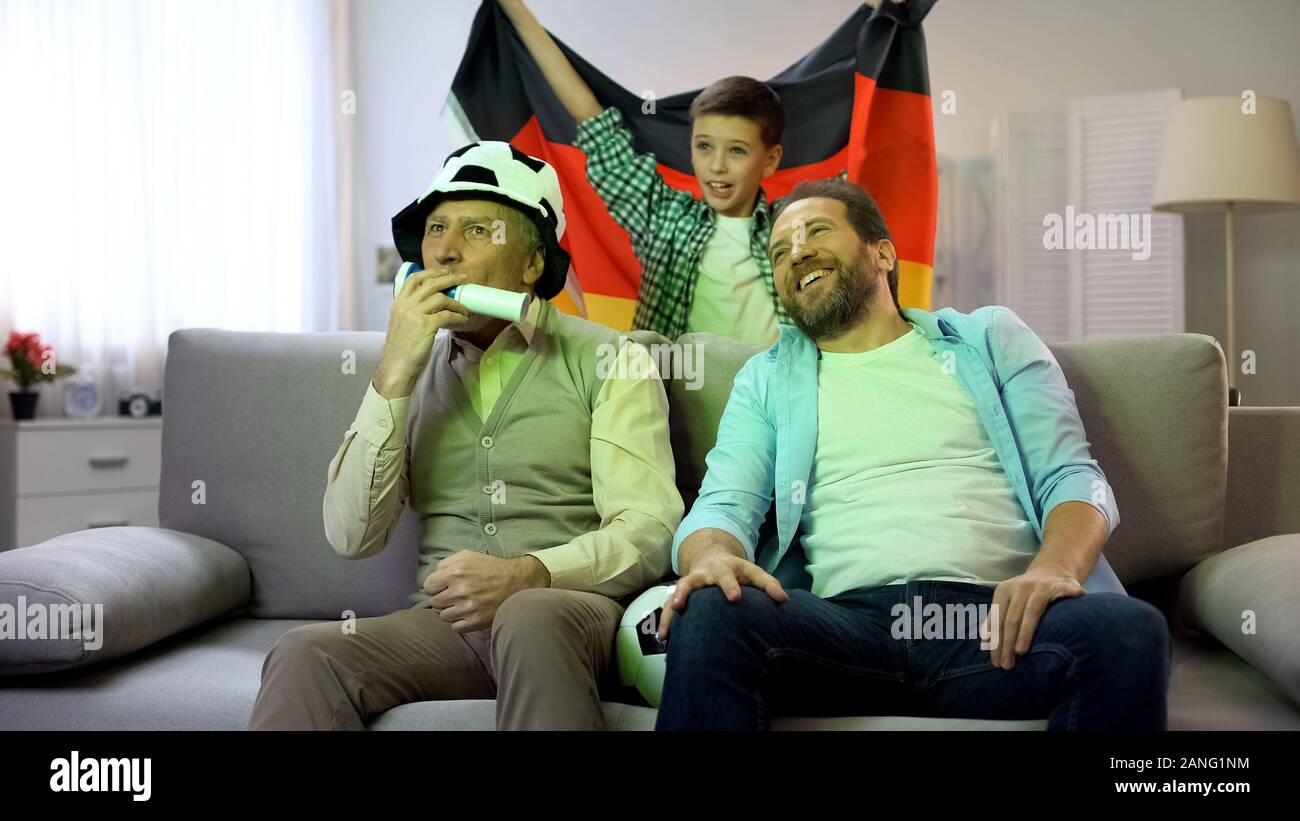 Happy german fans cheering for football team, friendly family having ...