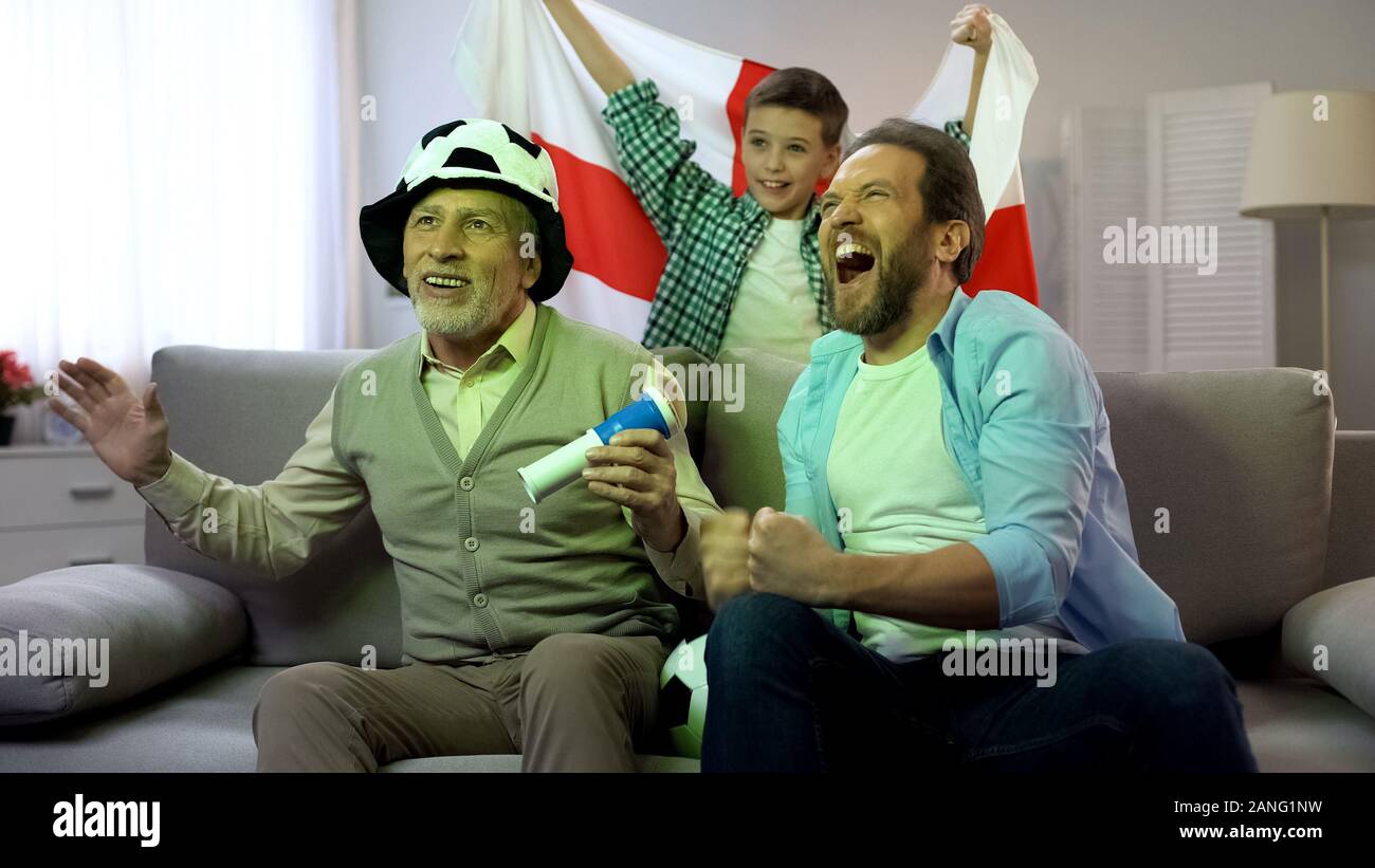 English fans watching football match at home, family leisure activity ...