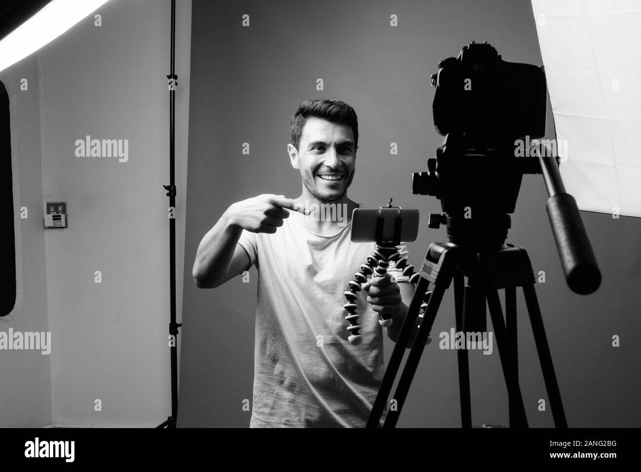 Young handsome Hispanic man vlogging with camera Stock Photo - Alamy