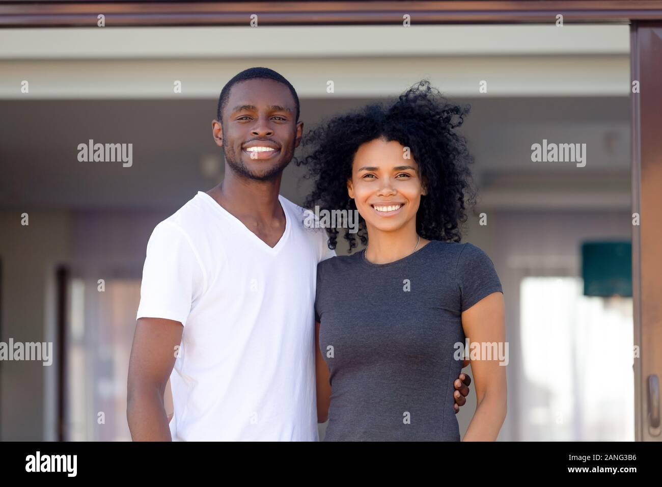 Portrait of happy black couple posing outside own home Stock Photo - Alamy