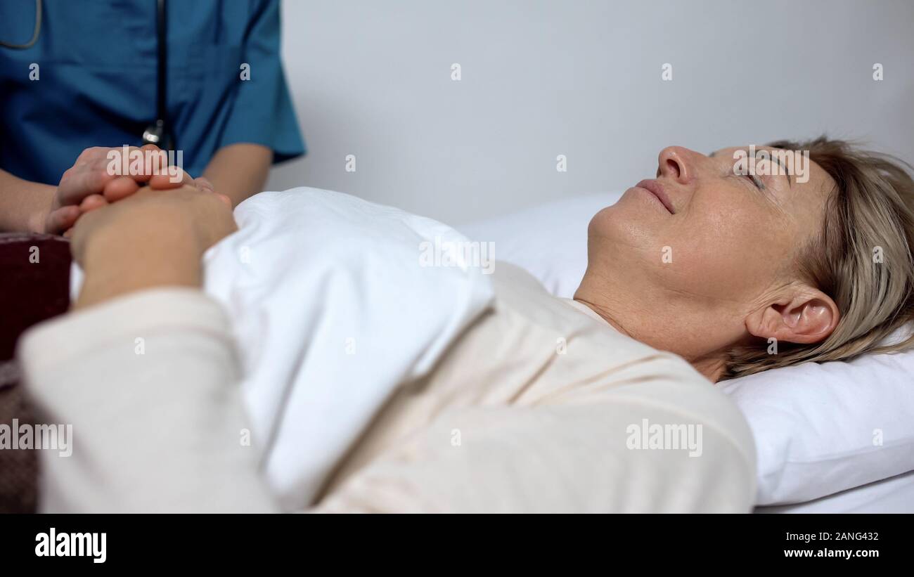 Hospice nurse patient holding hands hi-res stock photography and images ...