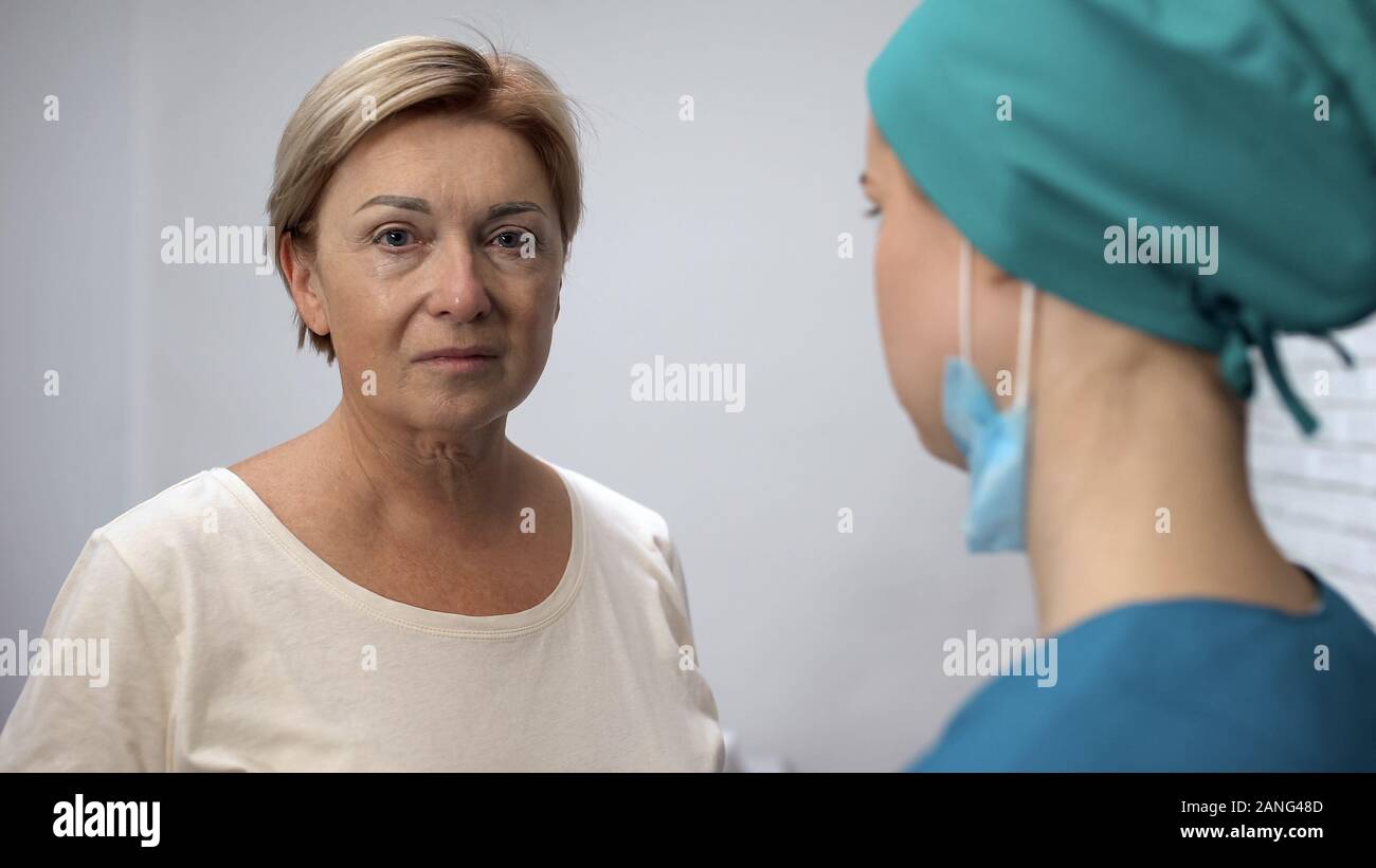 Crying woman looking at camera, received test results from doctor, bad ...