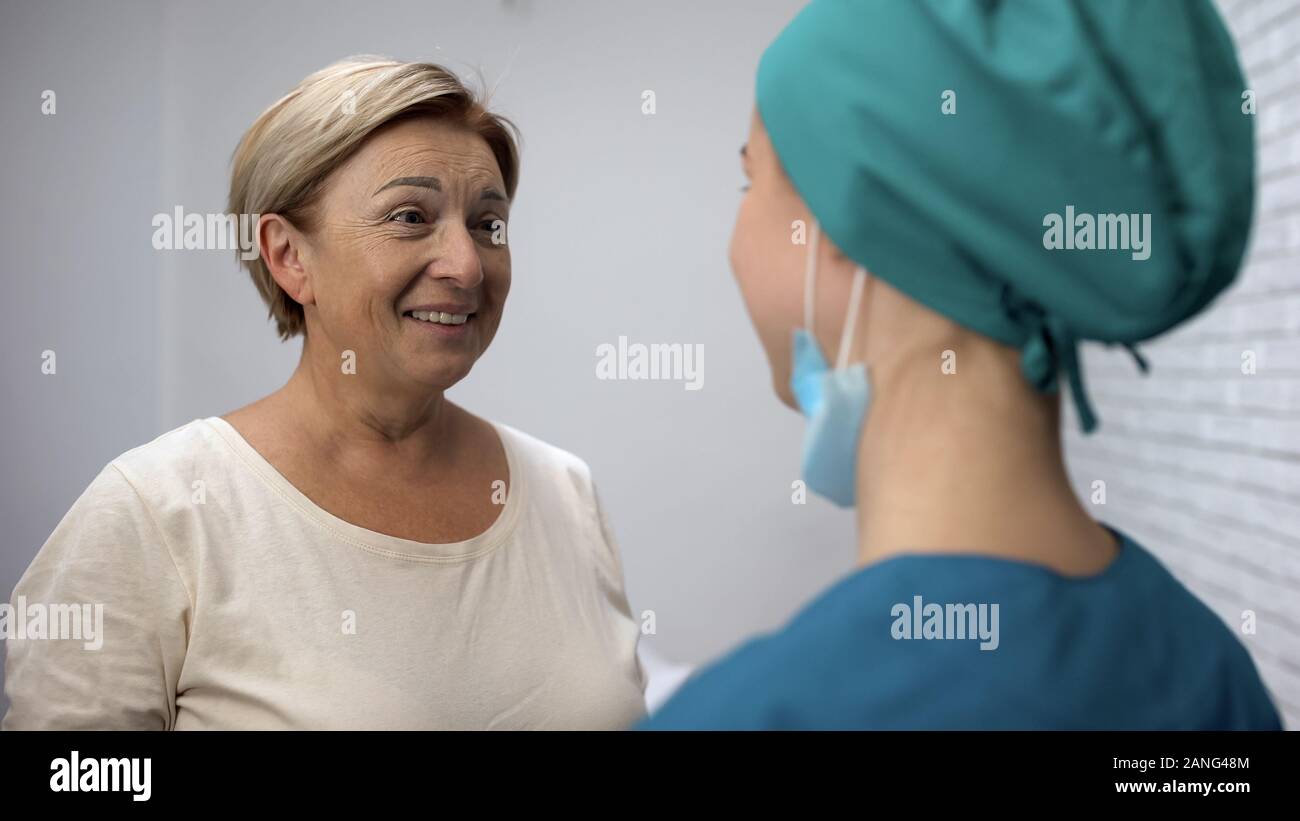 Woman listening to good news from doctor, feeling happy, recovery and ...