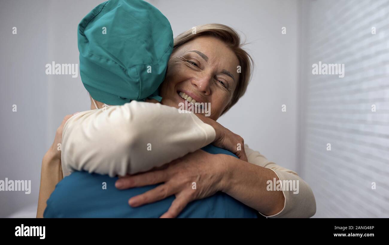 Happy woman hugging doctor, good test results, recovery and remission ...