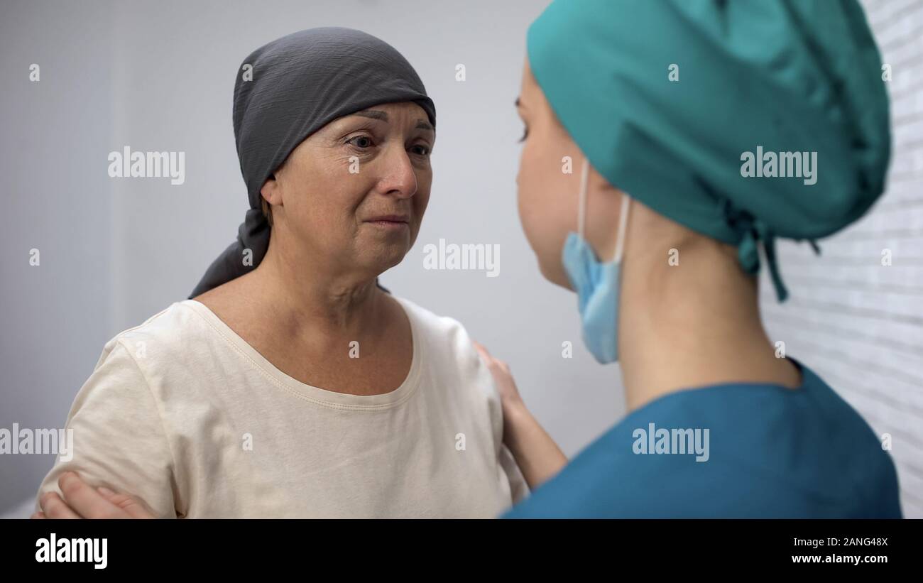 Doctor telling crying cancer patient about bad results of therapy ...