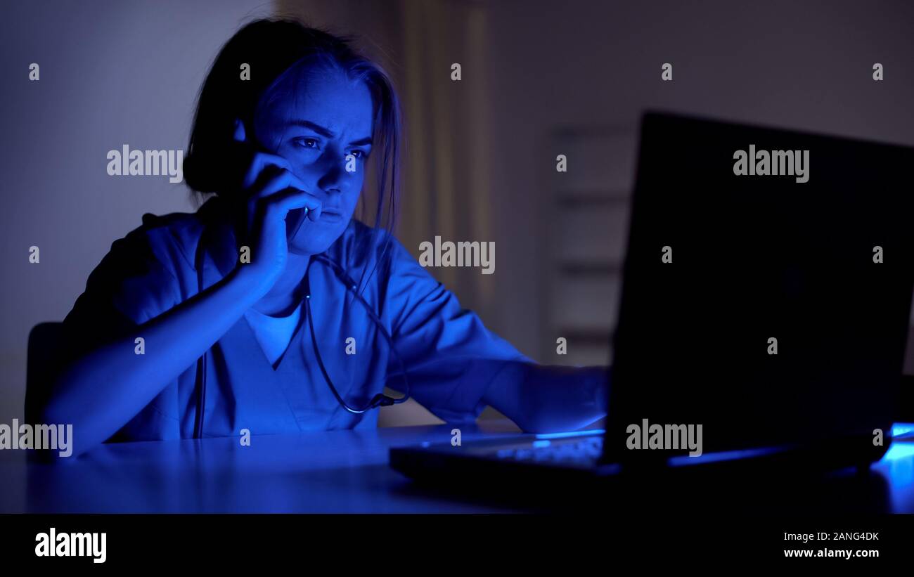 Ambulance operator taking call and filling medical card of patient, 911 ...