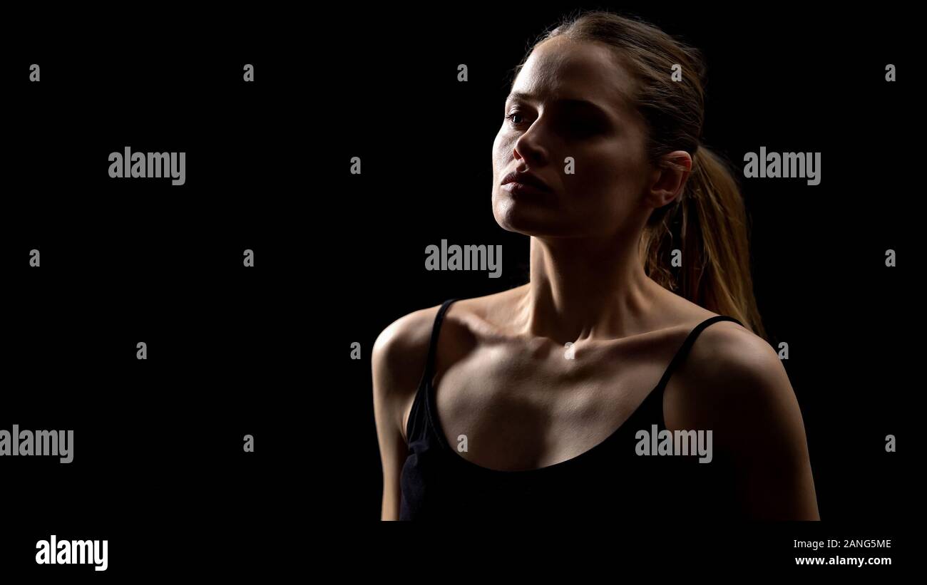 Determined lady ready to fight for women rights standing against dark ...
