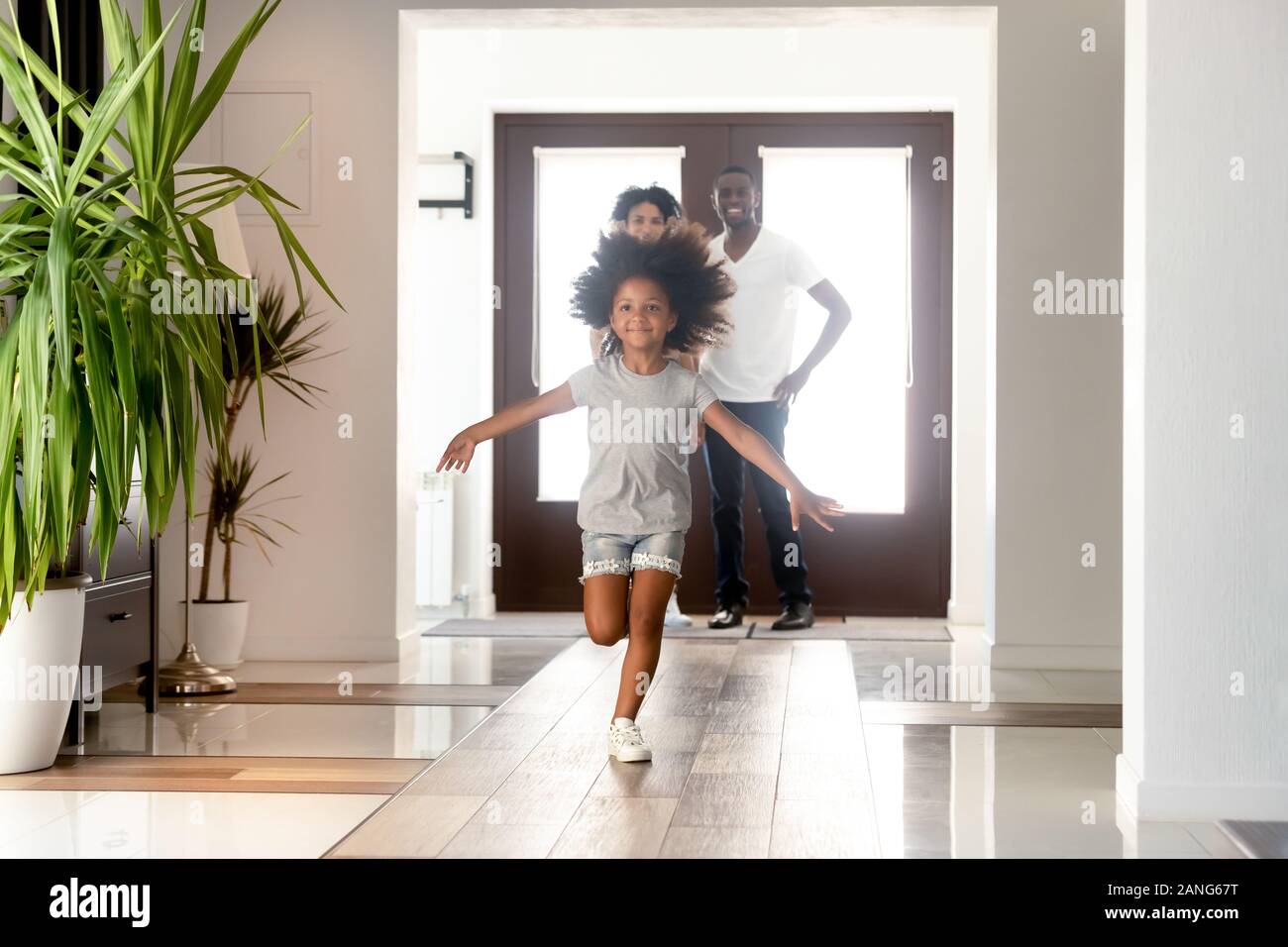 Small happy girl run in hallway moving into new house Stock Photo - Alamy