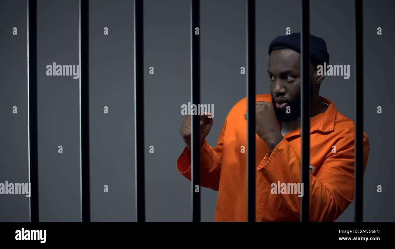 African-american male prisoner preparing to box in cell with inmate ...