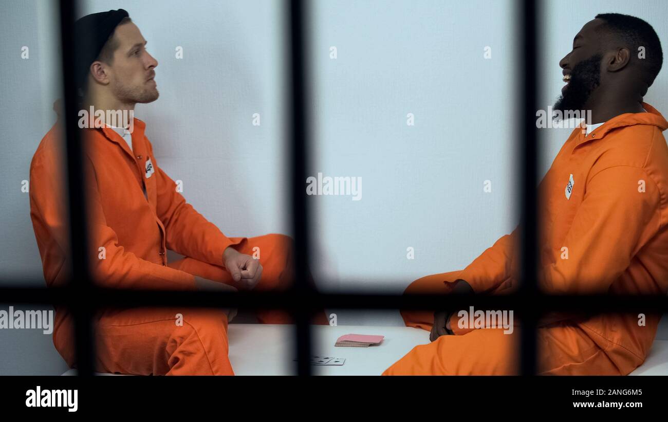 European and african-american inmates playing cards in cell, illegal ...
