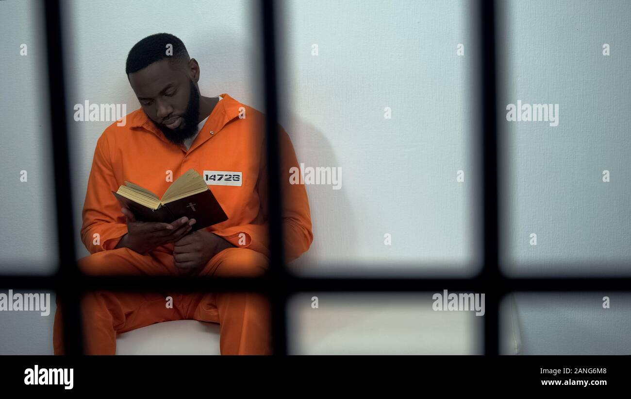 African-american prisoner reading holy bible, convicted sinner ...
