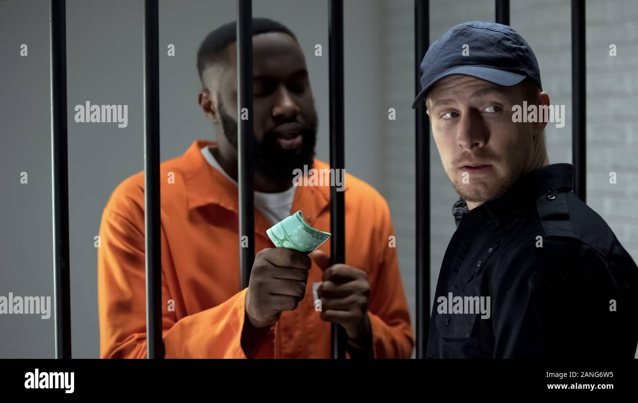 African imprisoned criminal giving euro bills to prison guard, faulty ...