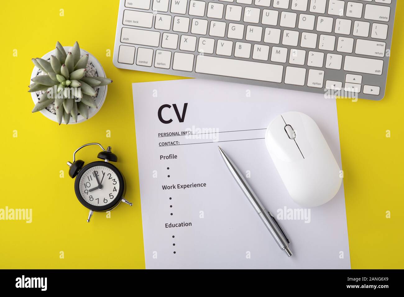CV with clock, computer keyboard, pen on yellow background, top view ...