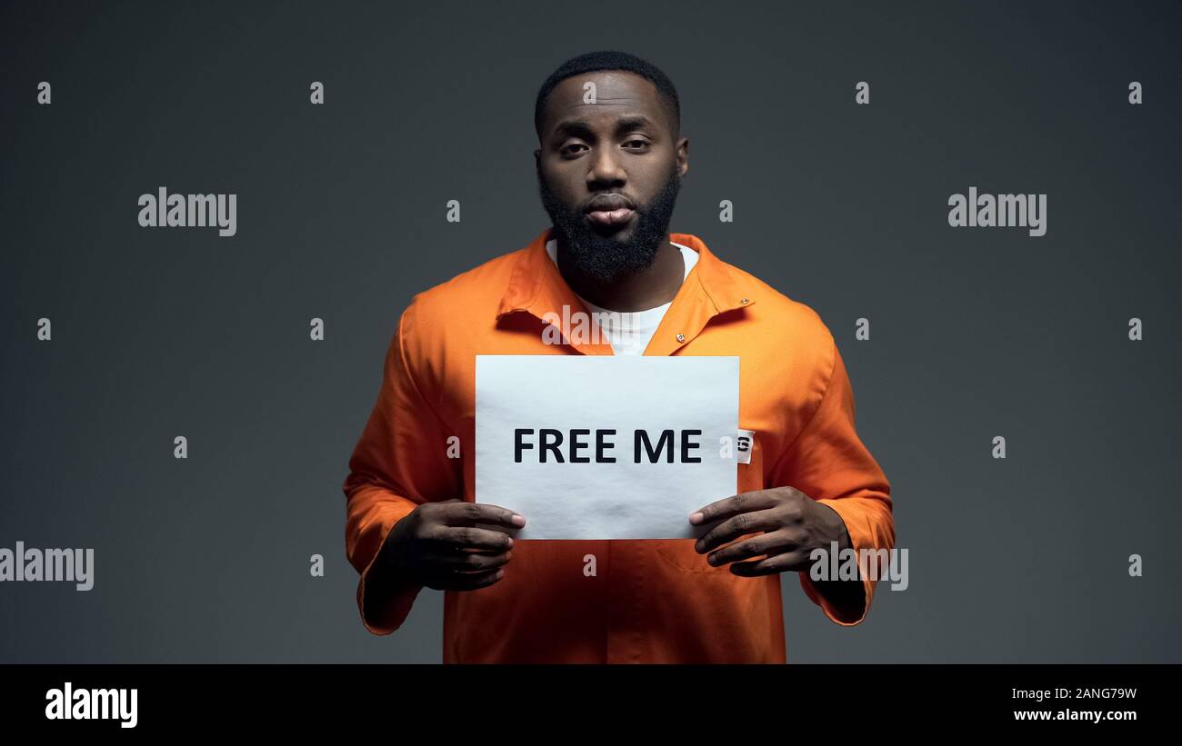 African-american prisoner holding free me sign in cell, innocent asking ...