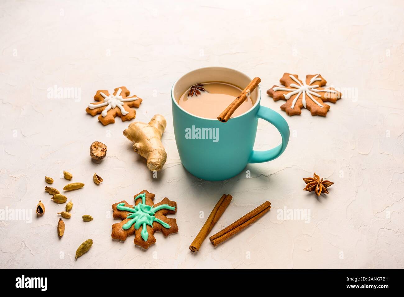 Traditional Indian masala tea chai with milk and spices on white ...
