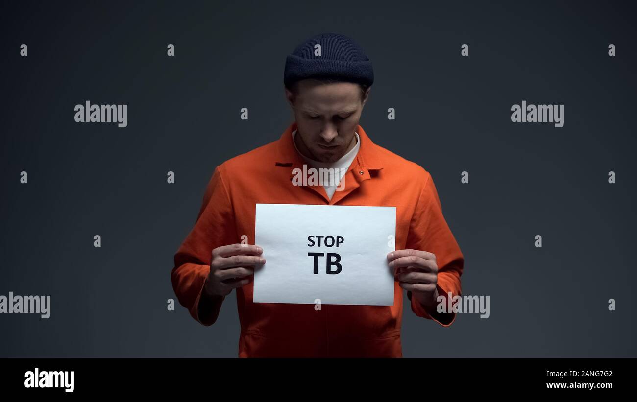 Male prisoner holding Stop TB sign, healthcare in prison, life ...
