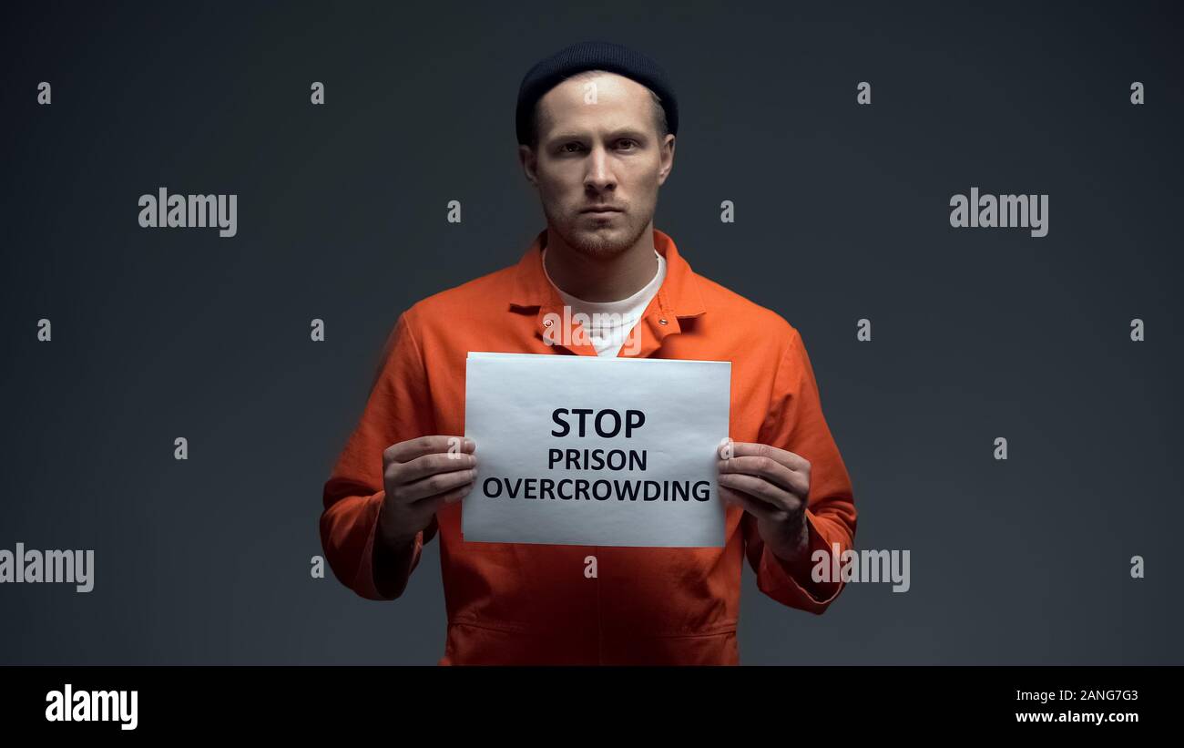 Prisoner holding Stop prison overcrowding sign in cell, life conditions ...