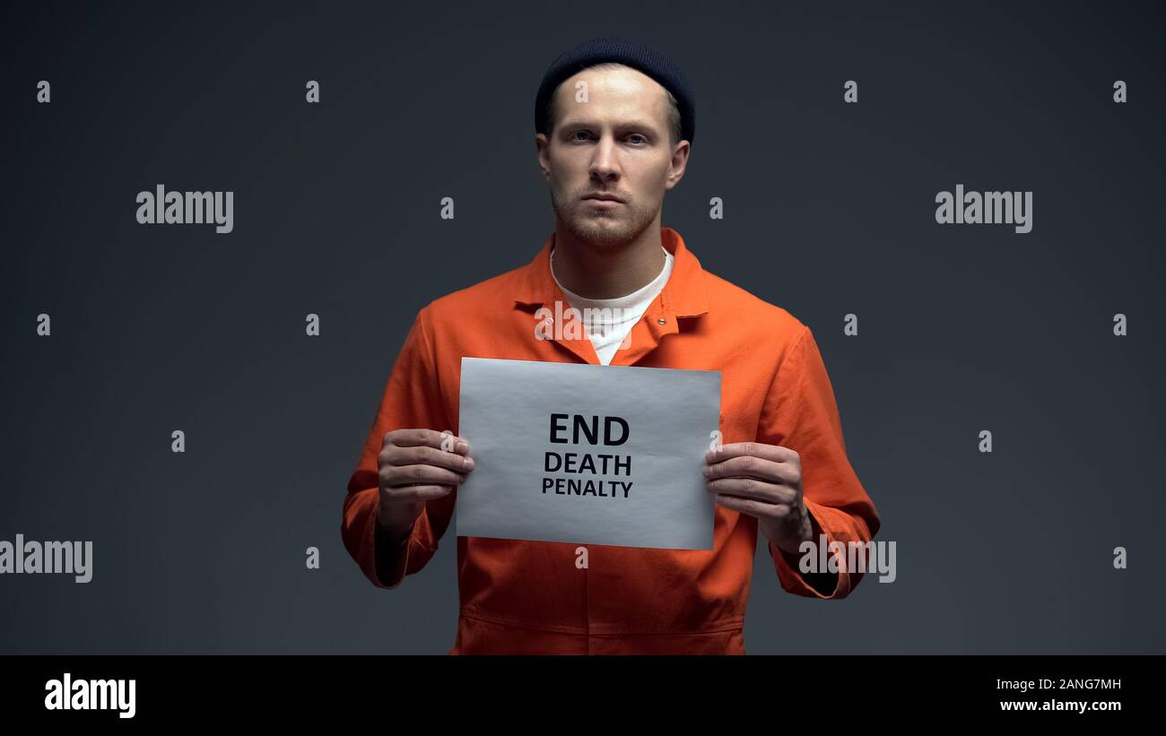 Caucasian male prisoner holding End death penalty sign in cell, asking ...