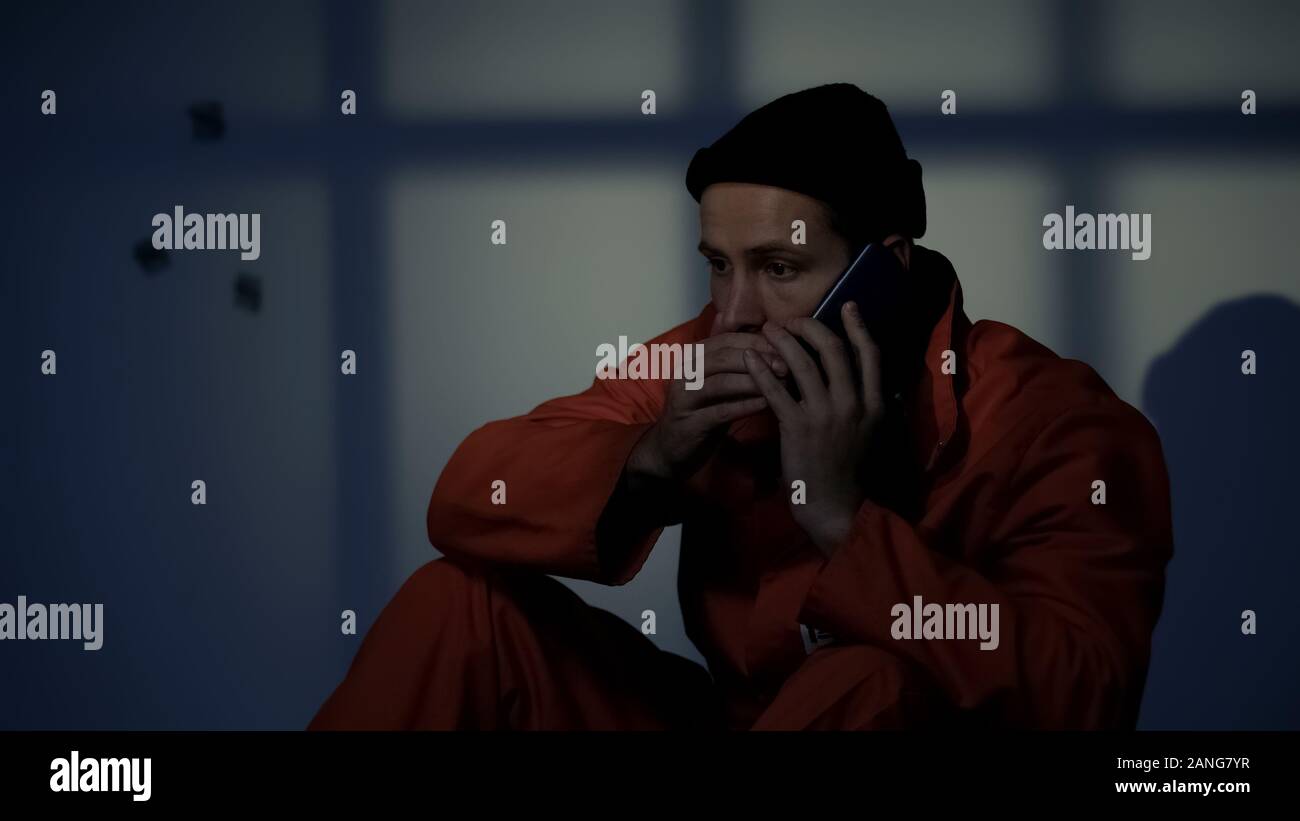 Imprisoned male making phone call, prison rules violation, gadget ...