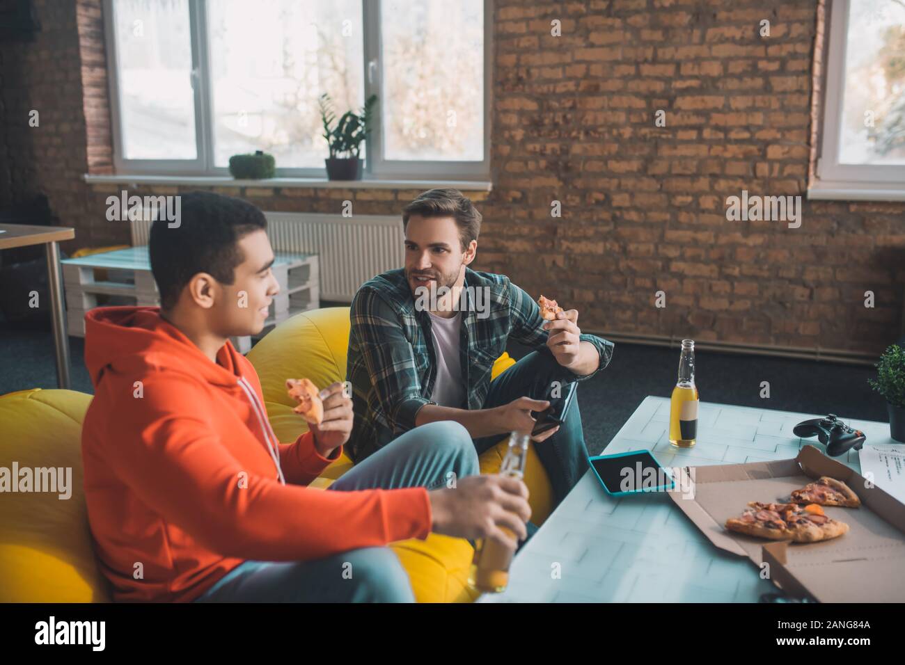 Delighted positive friends talking to each other Stock Photo - Alamy