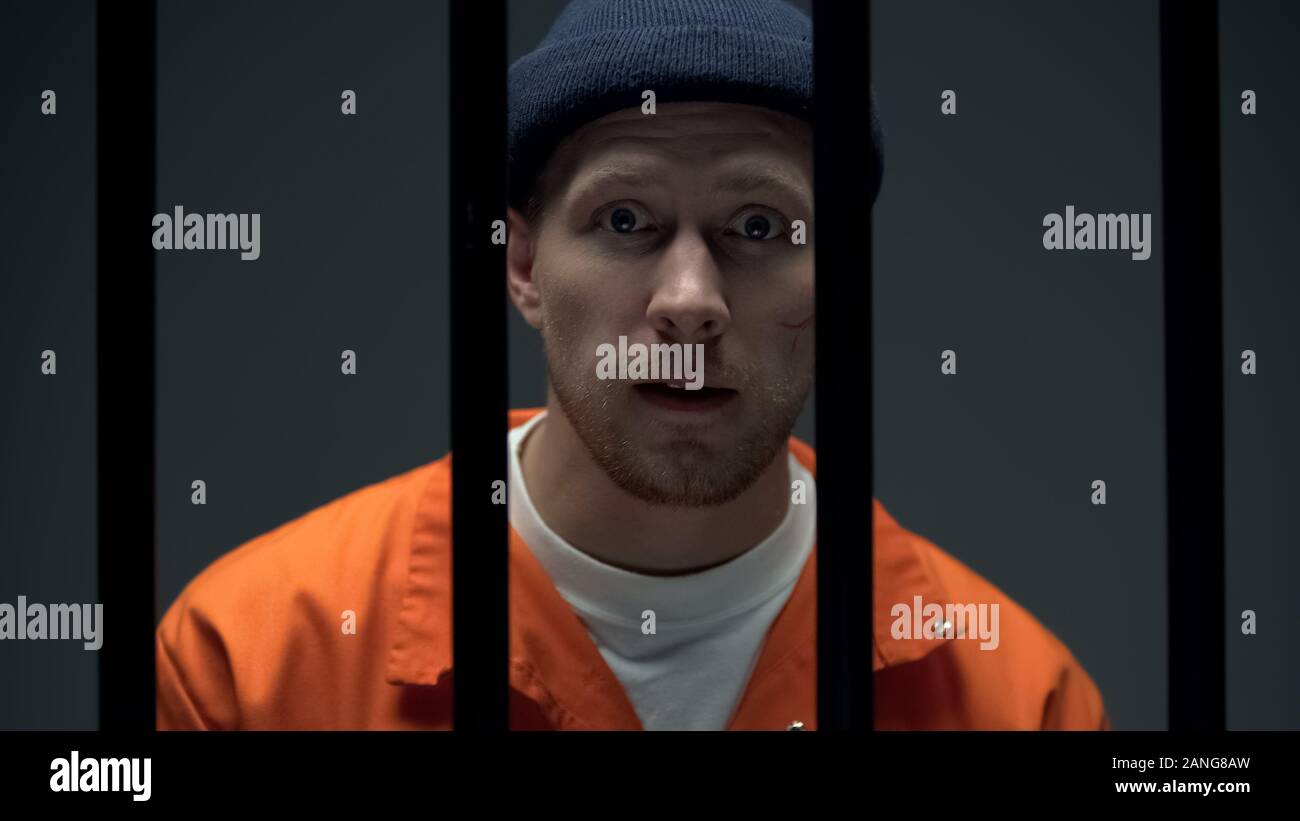 Arrogant prisoner throwing challenge, looking to camera, dangerous ...