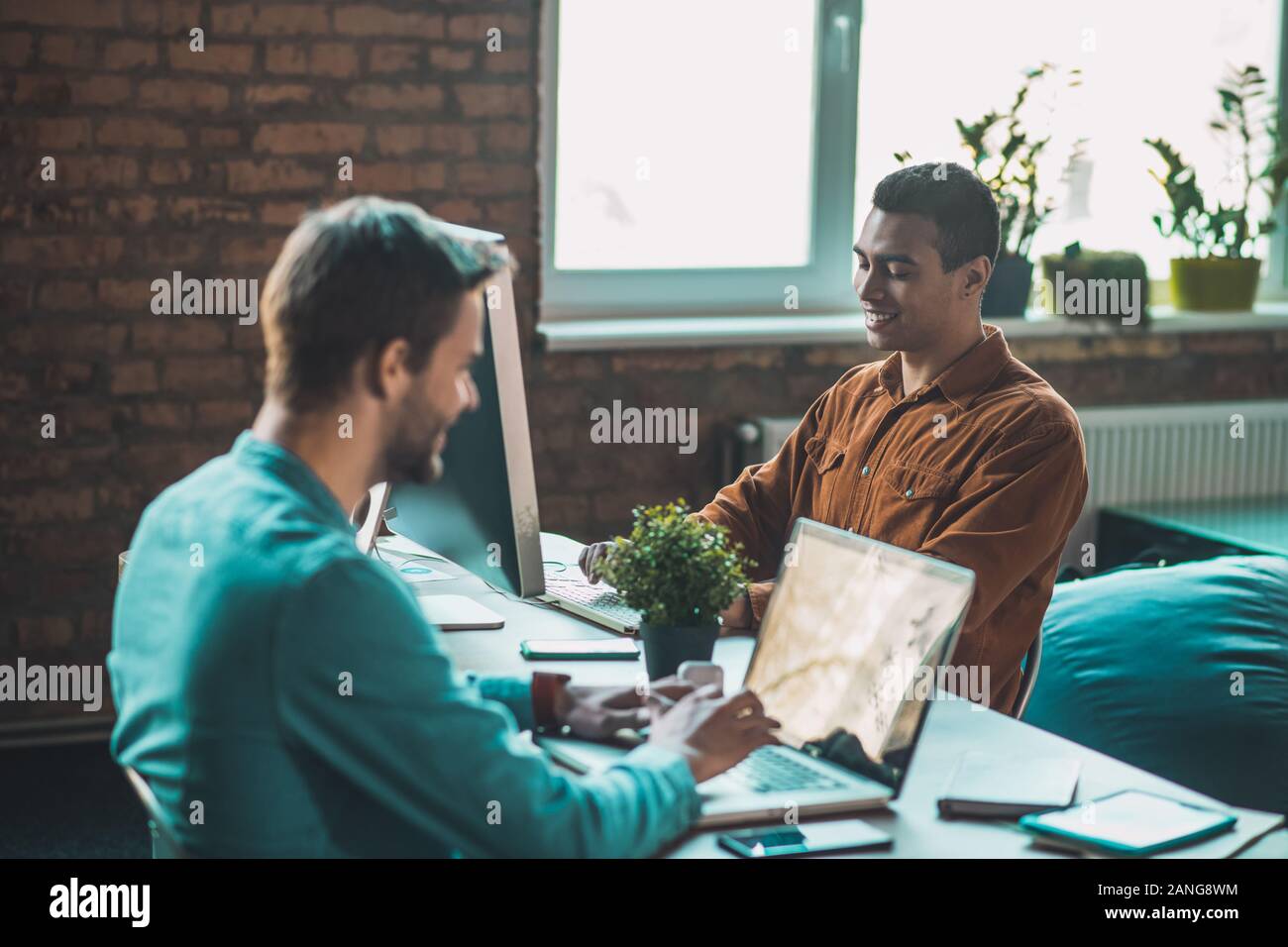 Positive nice man enjoying work in the office Stock Photo - Alamy