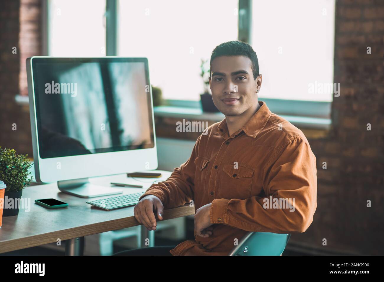 Nice smart young man turning to you Stock Photo - Alamy