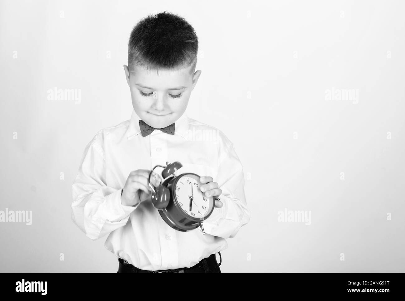 It is time. Morning routine. Schoolboy with alarm clock. Kid adorable ...