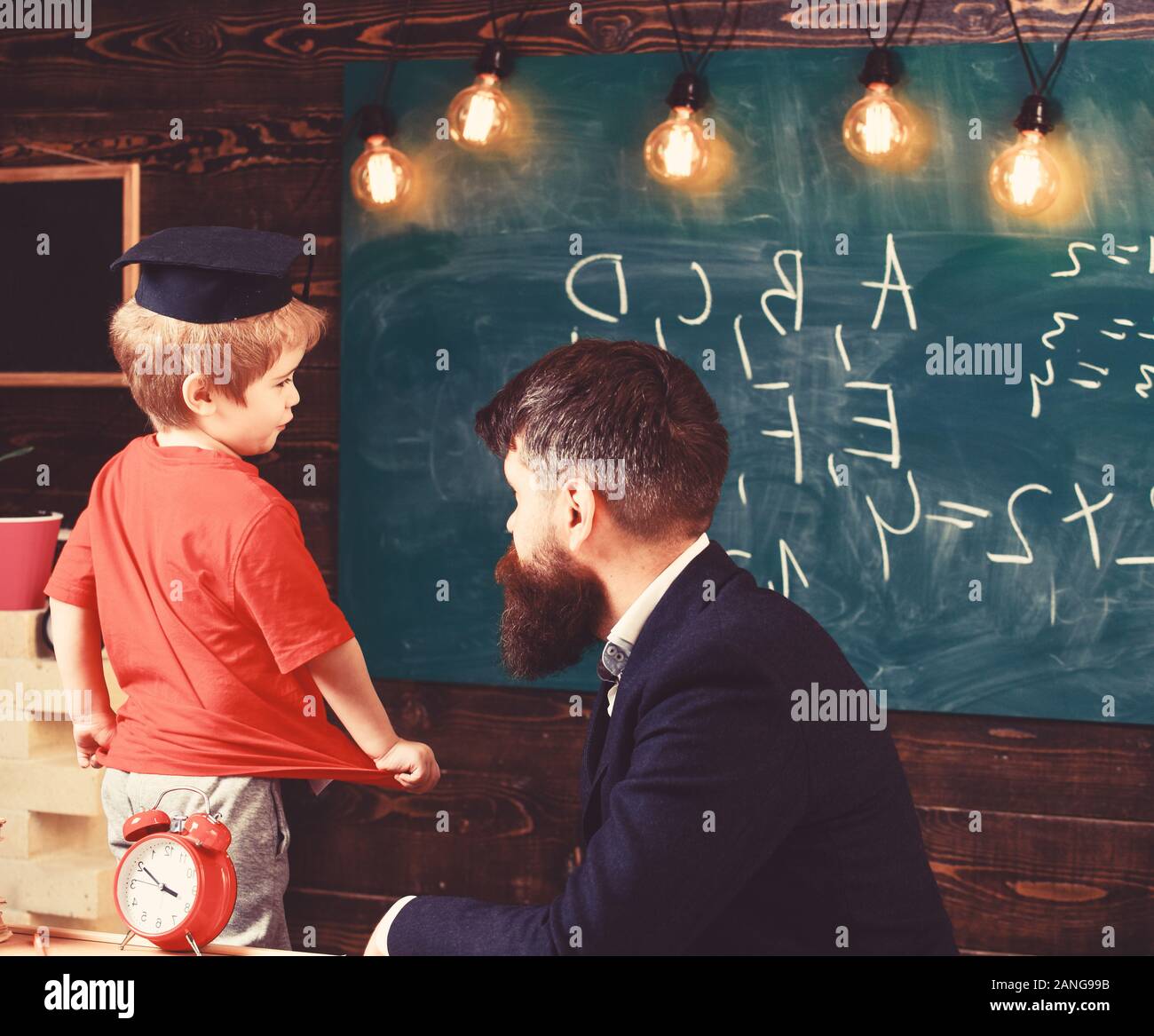Teacher and child talking in the classroom. Little schoolboy in Oxford ...