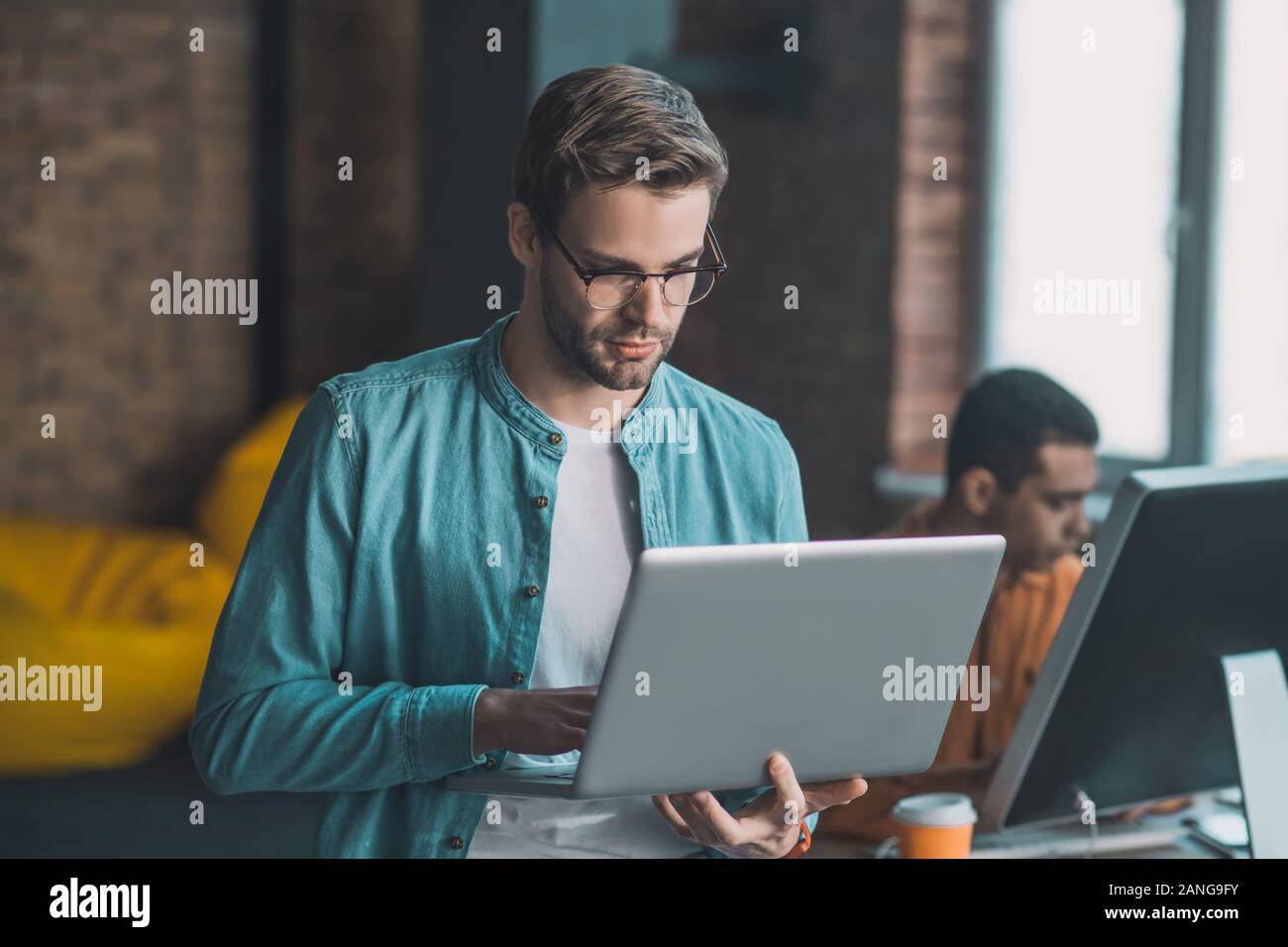 Nice good looking man working on his laptop Stock Photo - Alamy