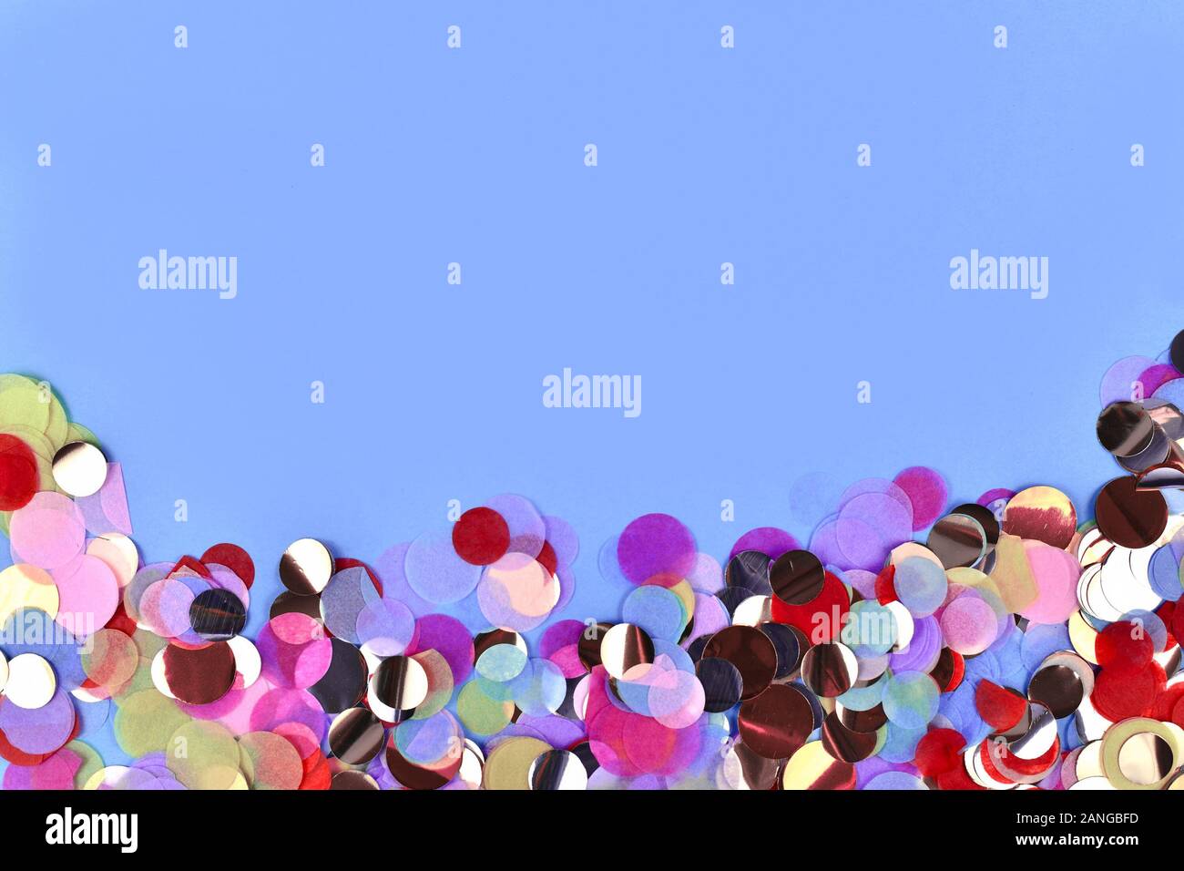Blue party background with colorful paper confetti at bottom border and copy space above Stock ...