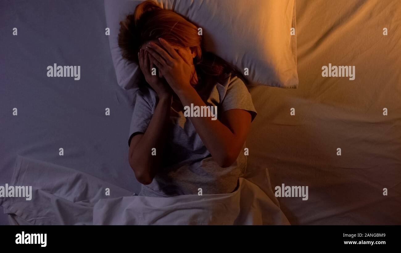 Woman hiding face while lying in bed, cant wake up in morning, tedious ...