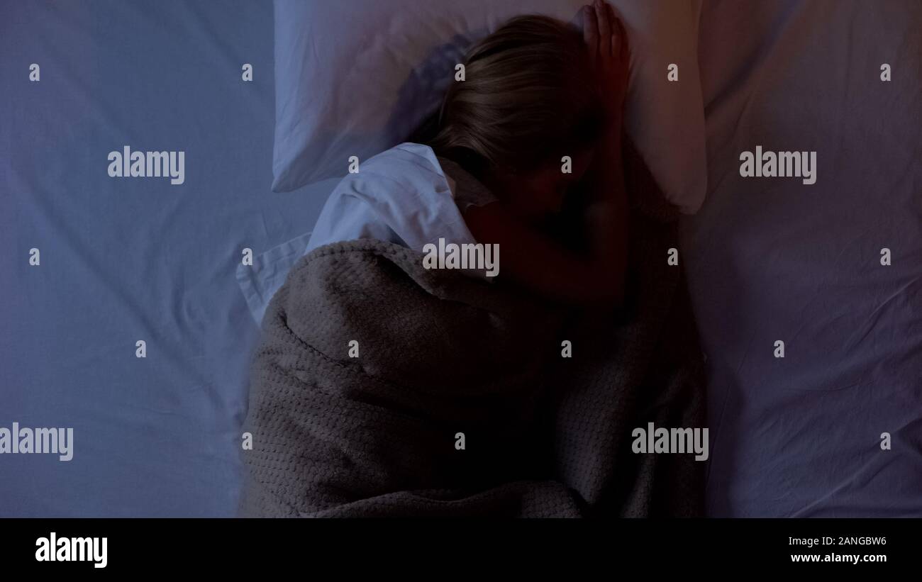 Female suffering nightmare, lying in bed at night, sleeping disorder ...