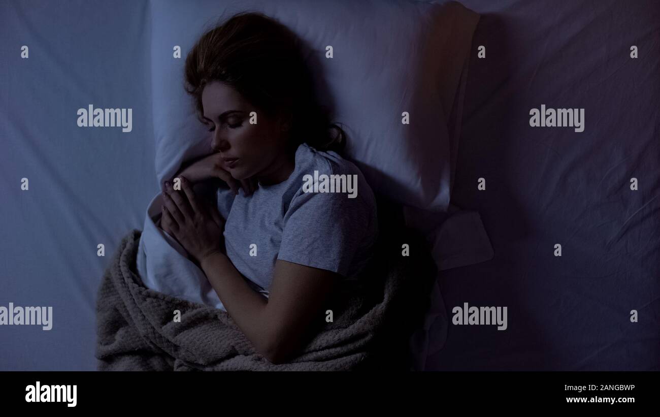 Young woman sleeping in comfortable bed at home, sleeping quality ...