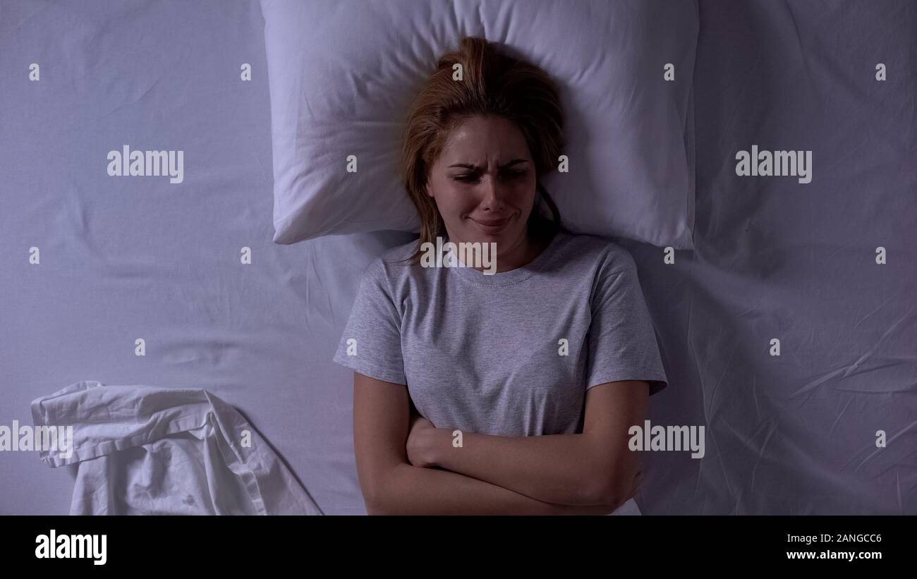 Young lady crying in bed, experiencing life difficulties, relationship ...