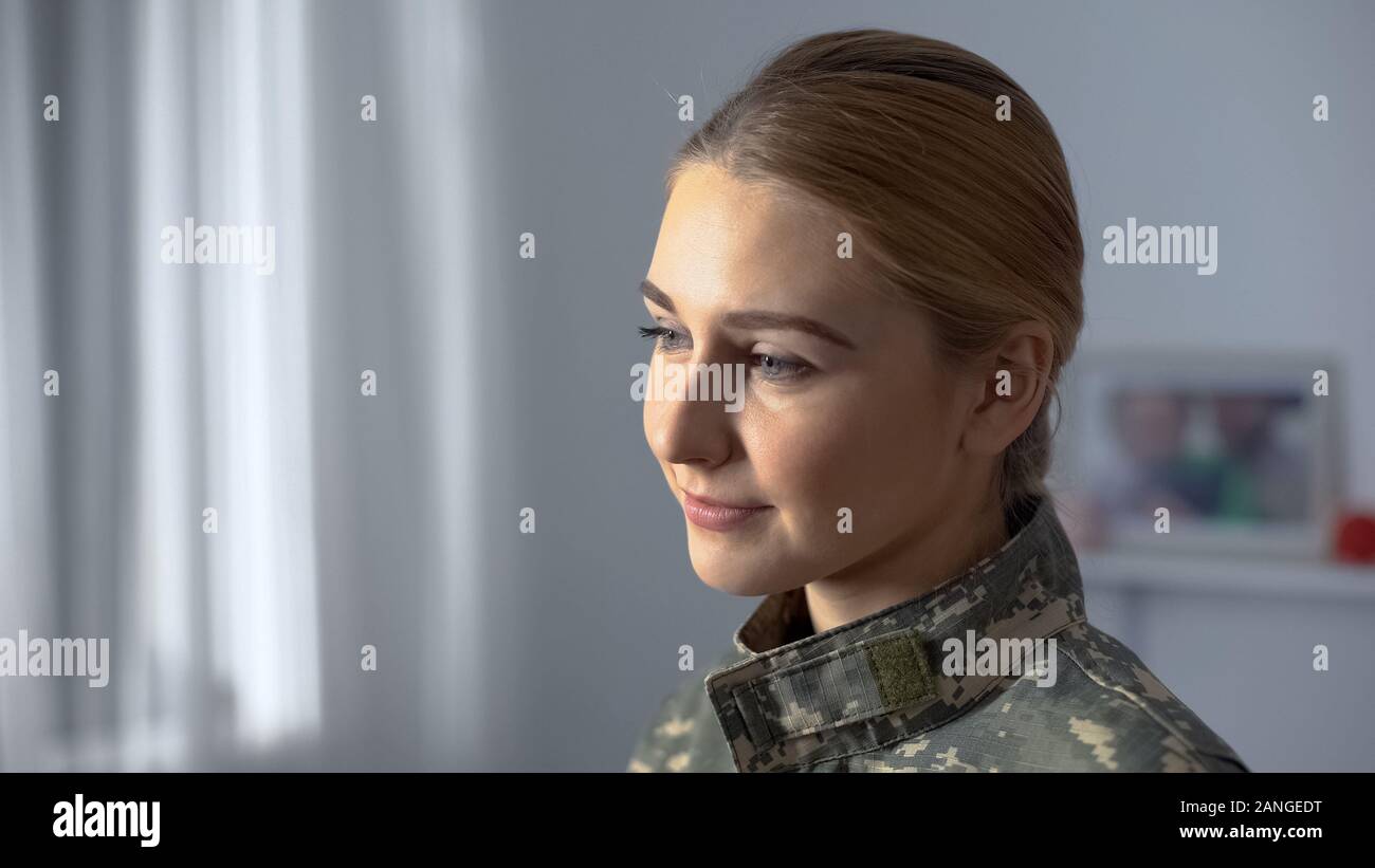 Happy female soldier in camouflage uniform watching military march in ...