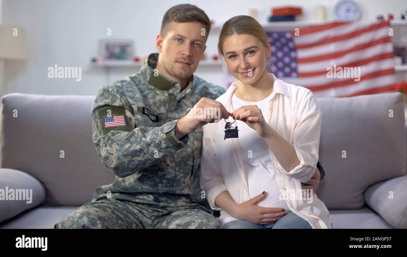 American male soldier and his wife holding house key reward for ...