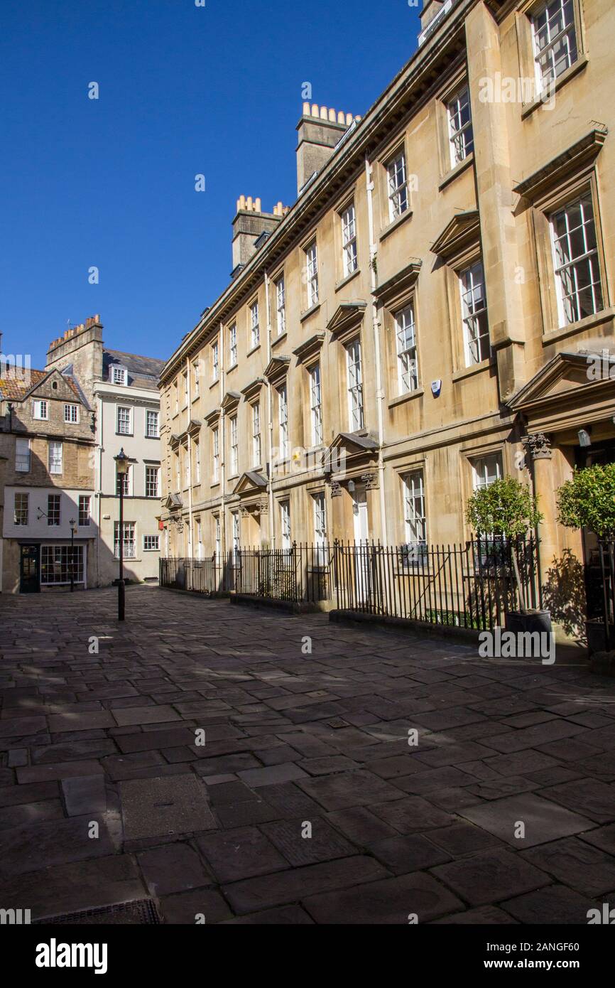BATH, UK - APRIL 10, 2019. Long shadows cast on alleyway in courtyard ...