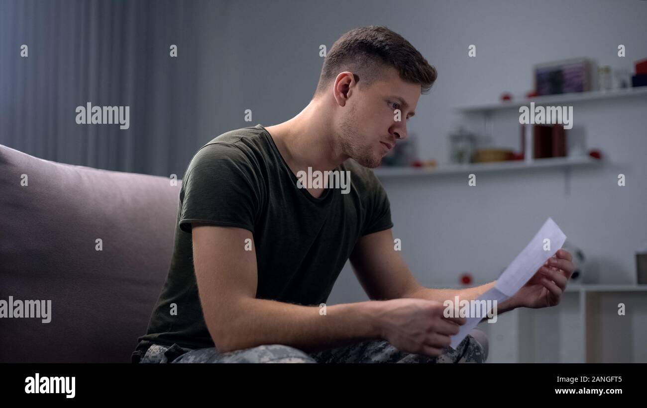 Male soldier reading letter from family, armed forces duty, feeling ...