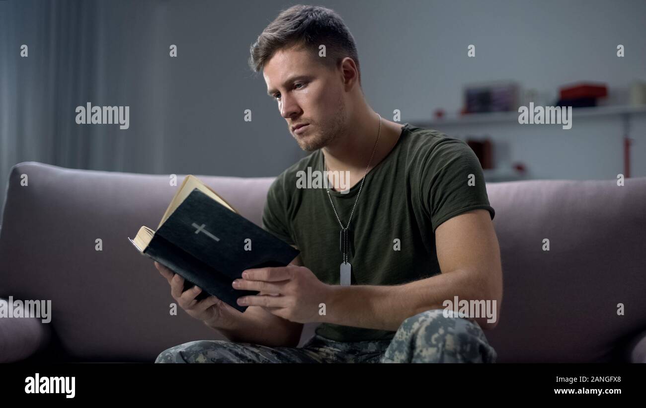 Serious male military reading bible, religion and faith, psychological ...