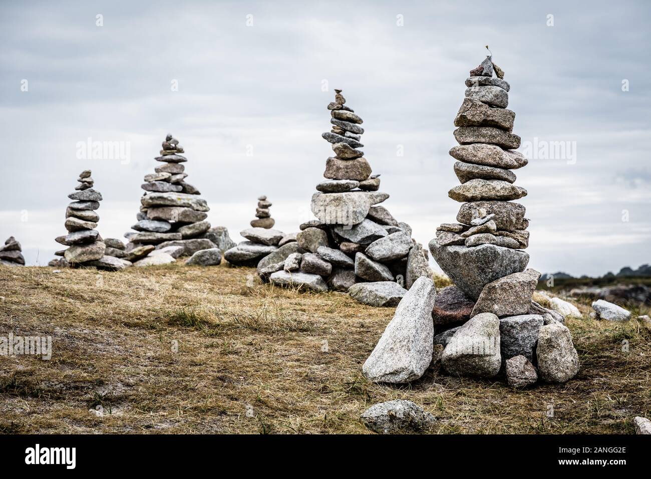 Several man-made granite stone stacks (called cairns) on the coastal ...