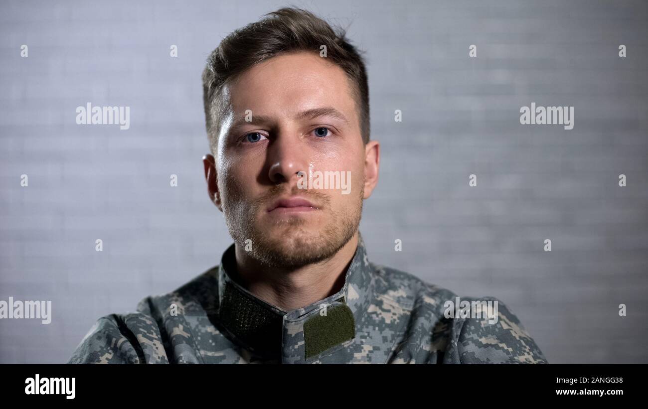 Crying male soldier looking at camera, military posttraumatic syndrome ...