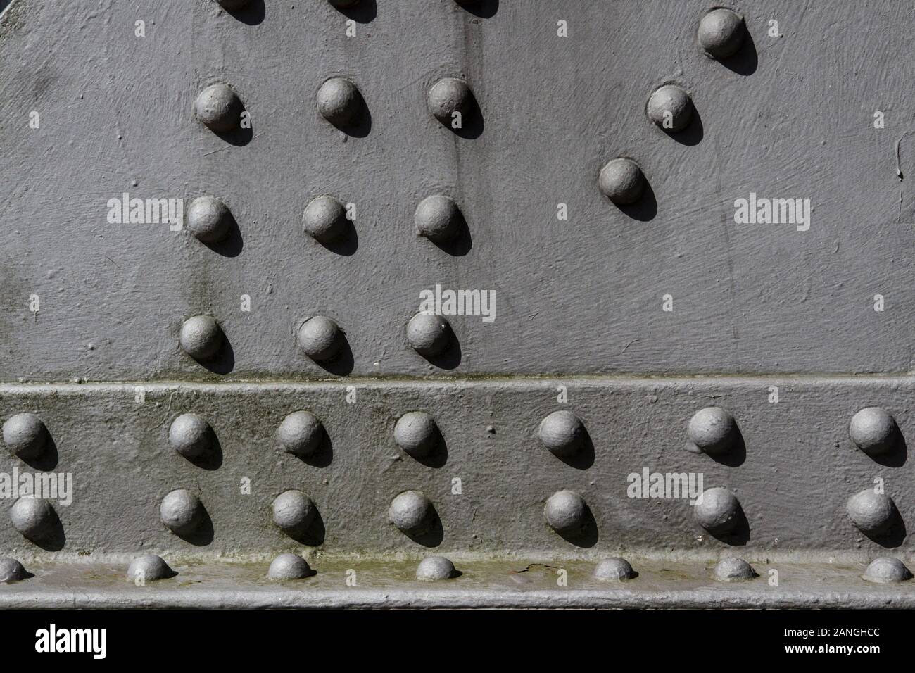 Background with pattern of metal rivets on crane Stock Photo - Alamy