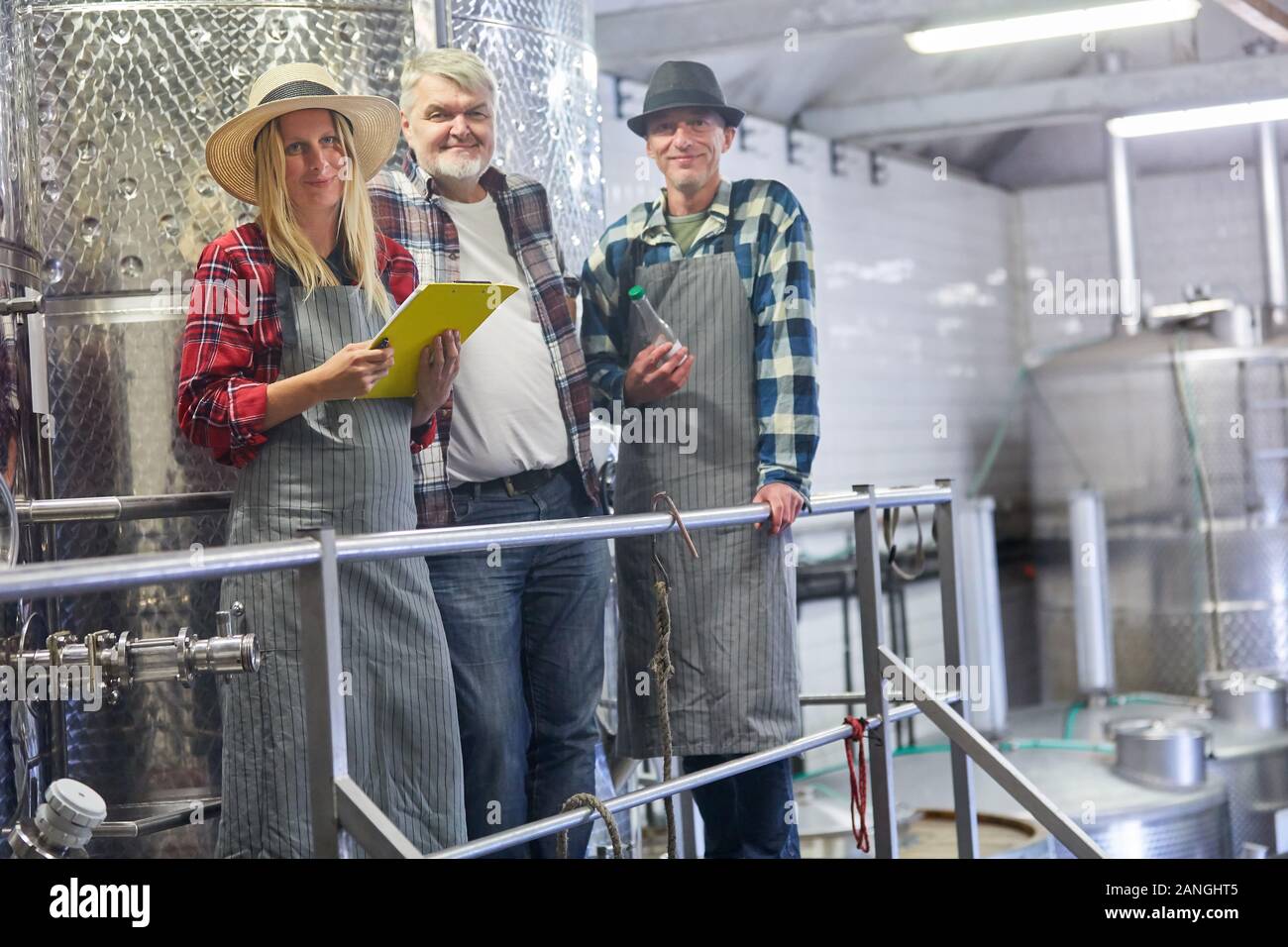 Winery team with cellar master and trainee with checklist at the ...