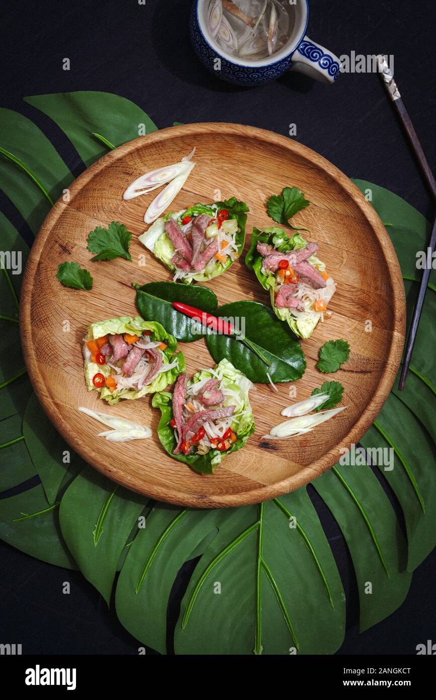 Spicy thai beef and lettuce canape with glass noodles Stock Photo - Alamy